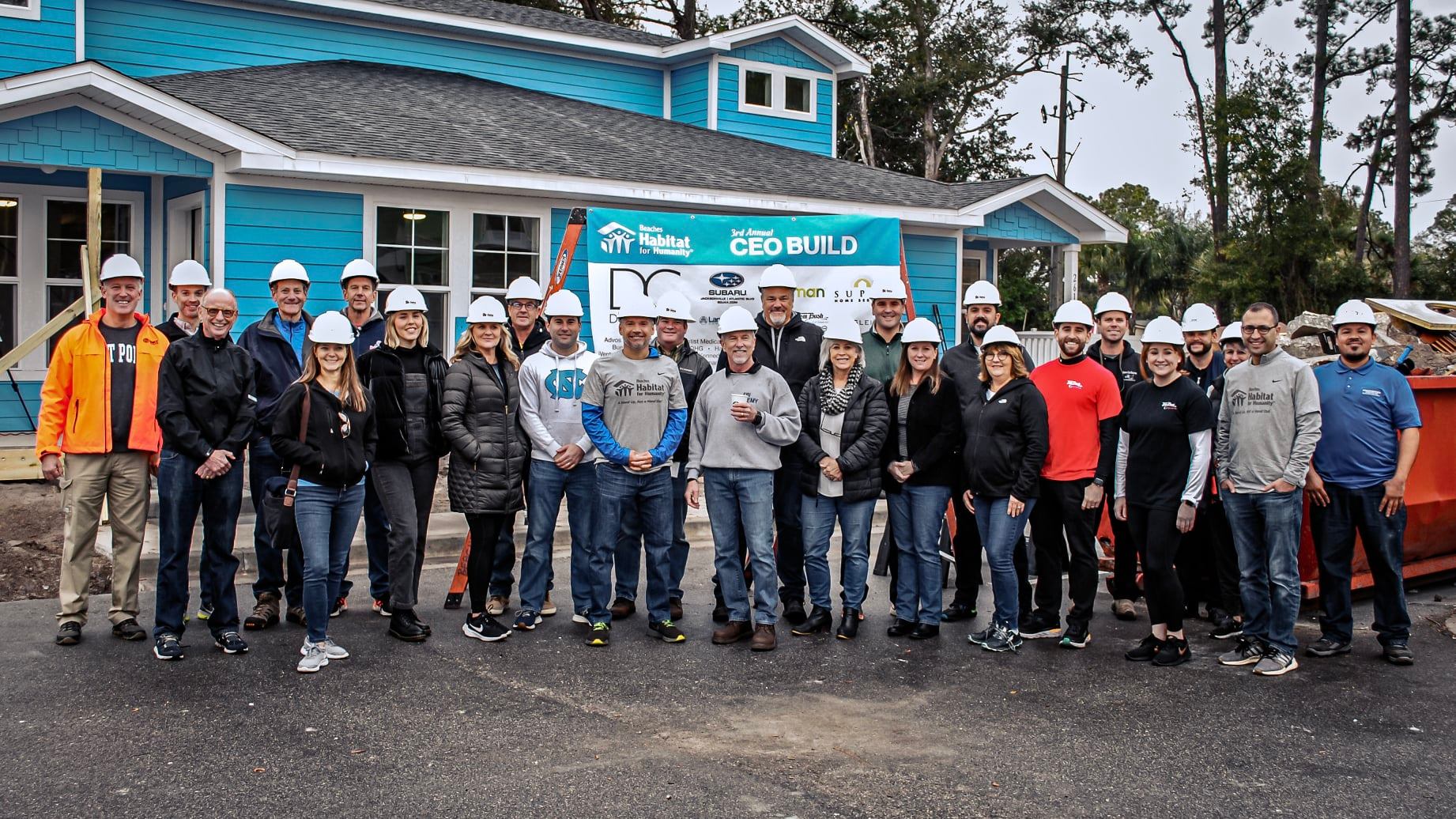 Team of top executives helps build homes as part of Beaches Habitat for ...